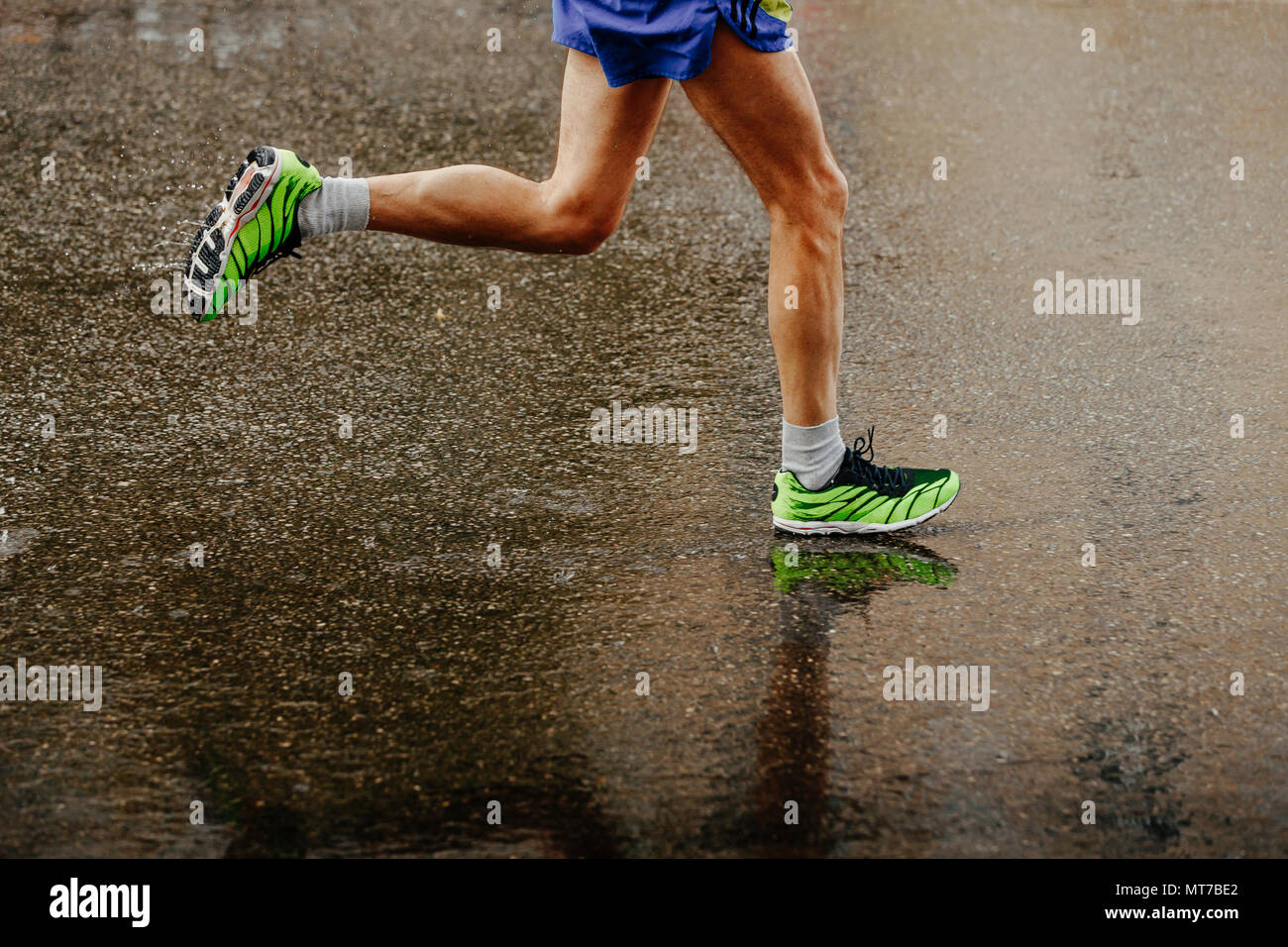 legs athlete runner running on wet from rain gray asphalt Stock Photo ...
