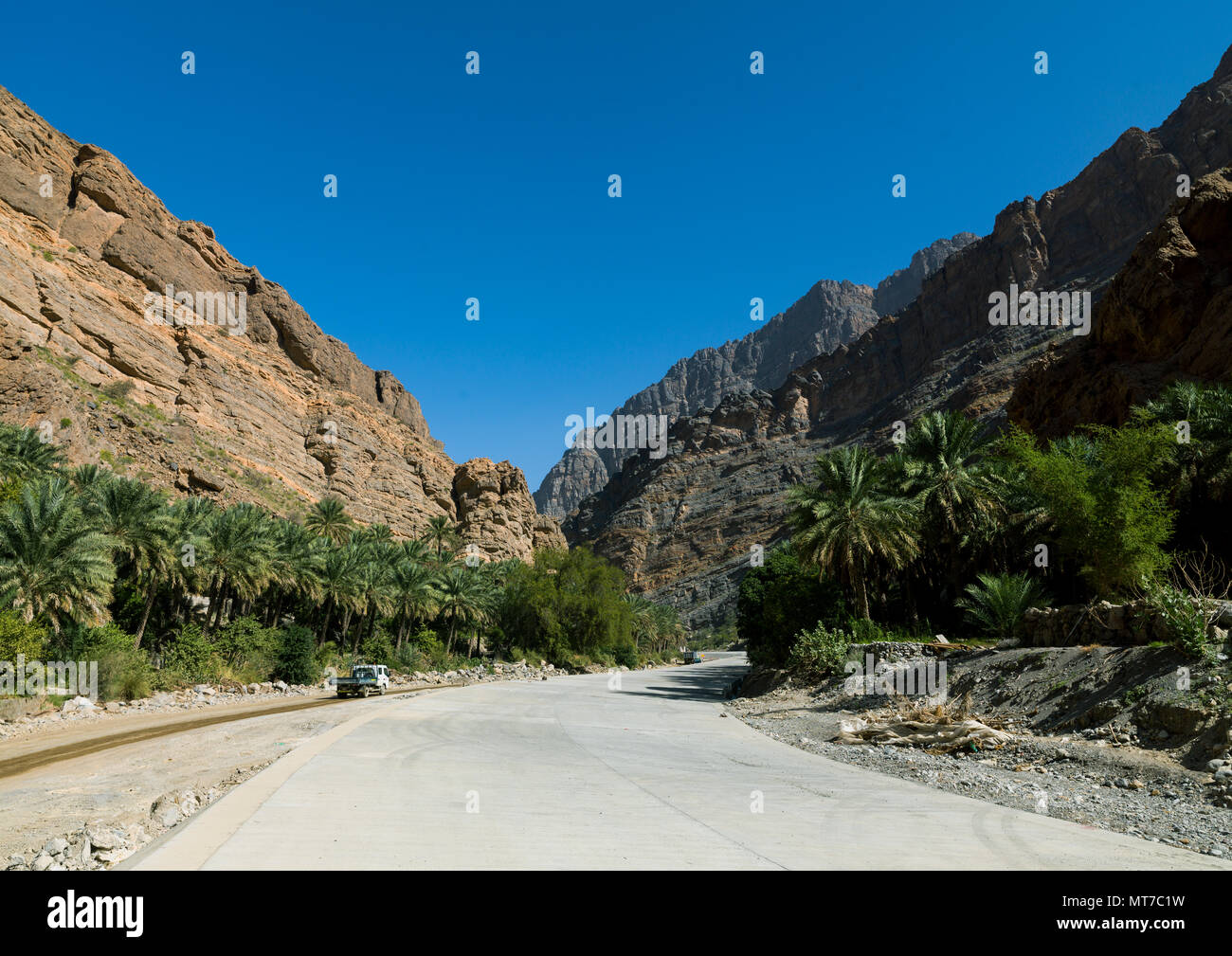 Truck on the road in a wadi, Al Hajar Mountains, Bilad Sayt, Oman Stock ...