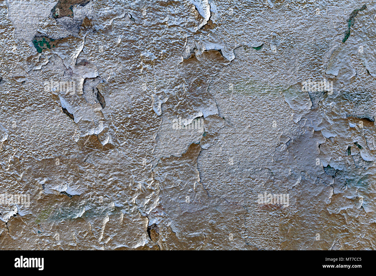 Damaged and peeling silver paint of an old wall of abandoned building ...