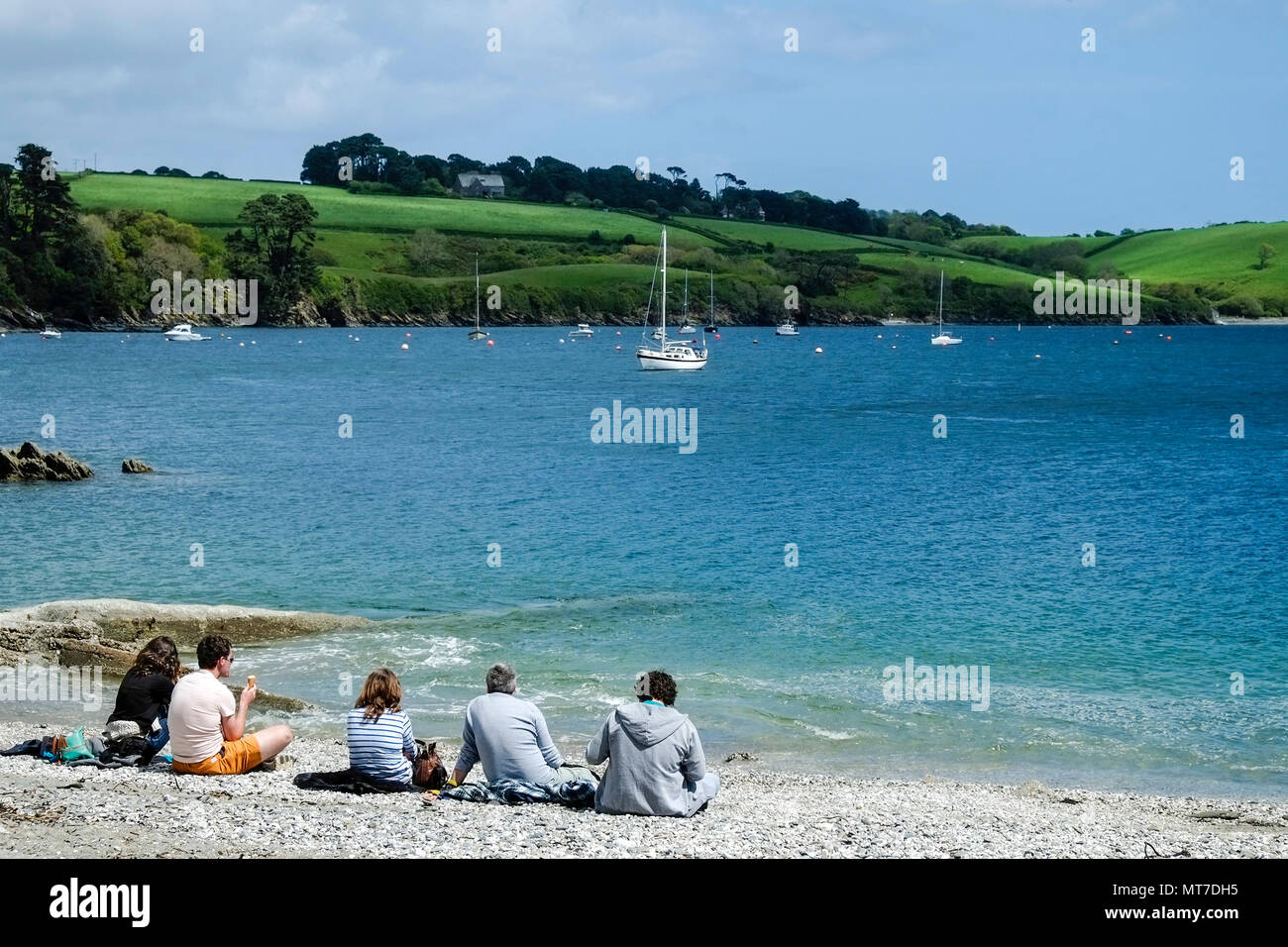 Holidaymakers relaxing on the private beach Polgwidden Cove at Trebah ...