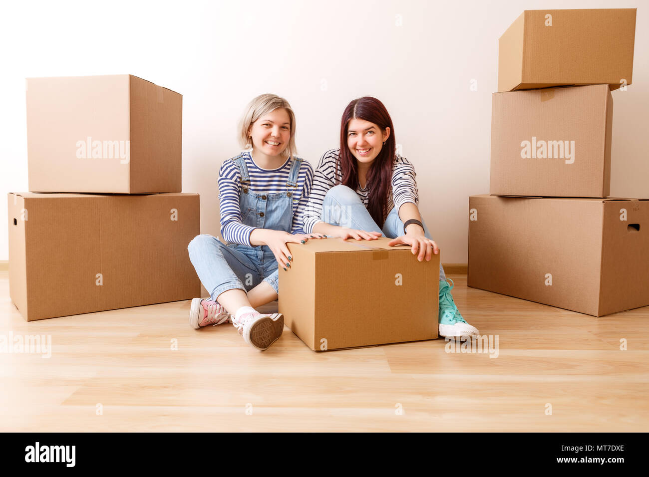 Photo of two women among cardboard boxes Stock Photo - Alamy
