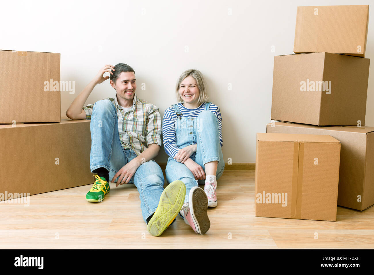 Image of young couple among cardboard boxes Stock Photo - Alamy