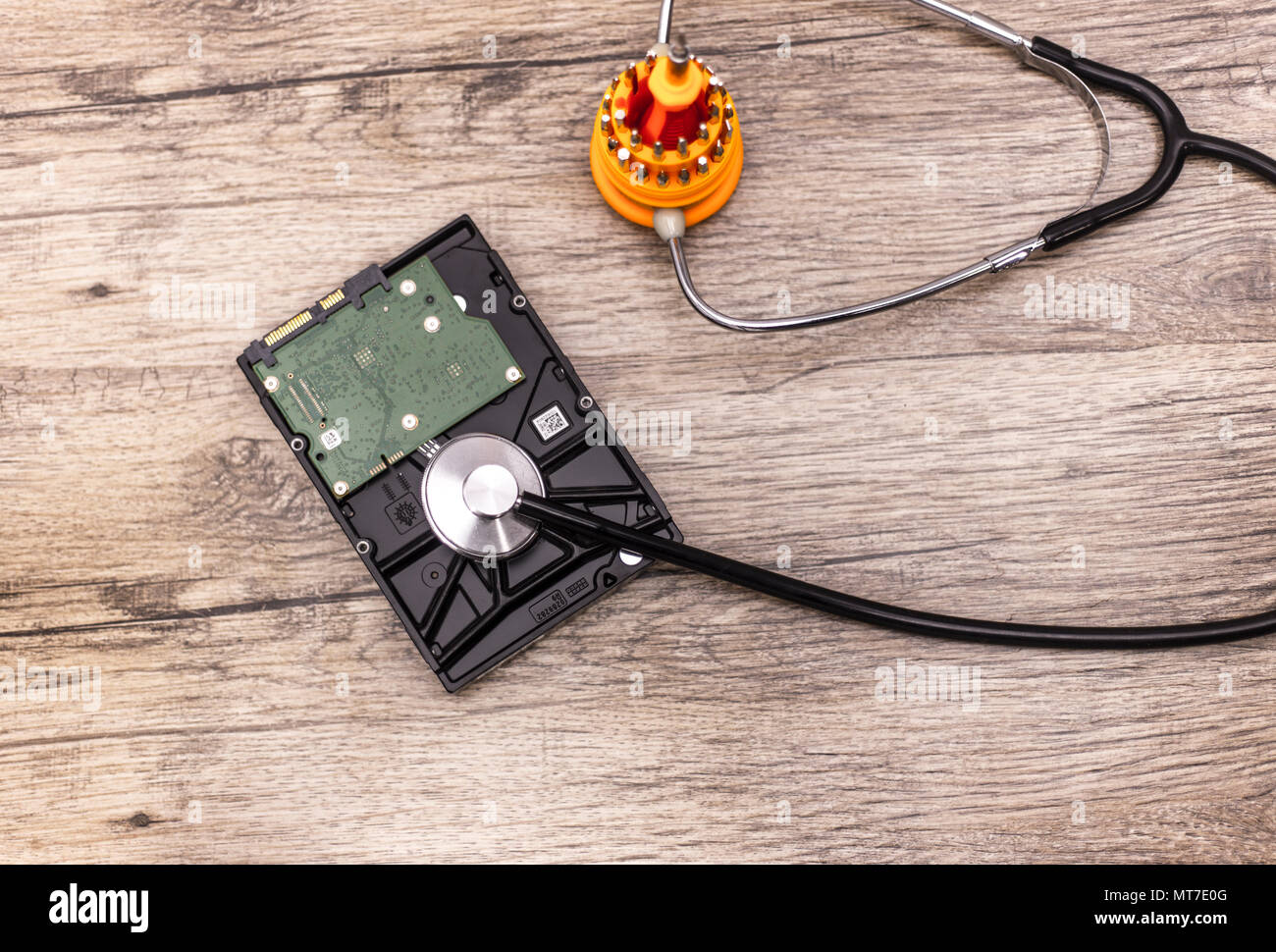 screwdriver cures a hard disk with stethoscope Stock Photo - Alamy