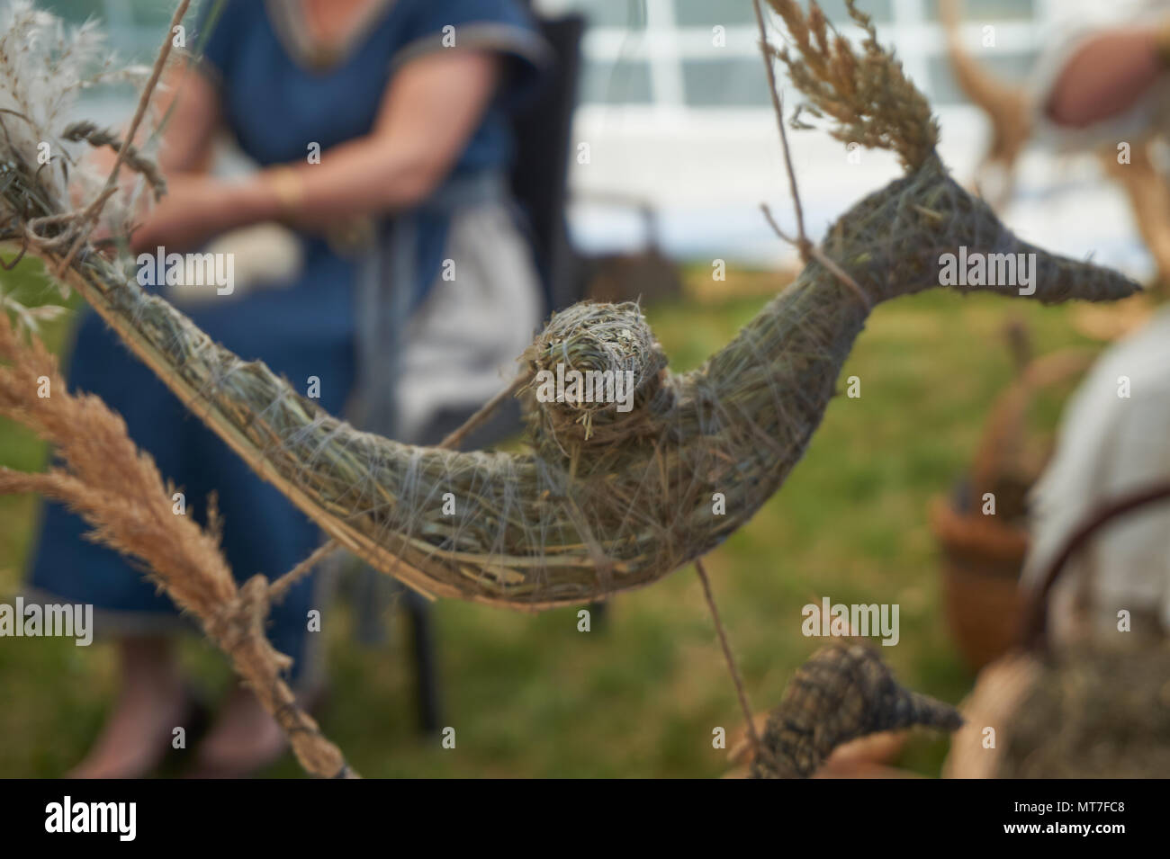 Hand-crafted flying bird made from dried grass and straw bound with ...