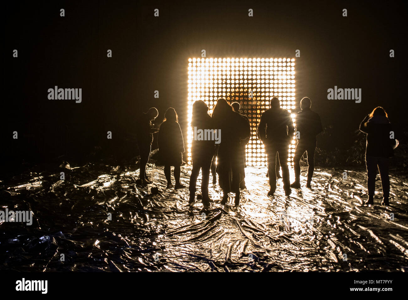 Night scene high contrast photo of people at outdoor contemporary art ...