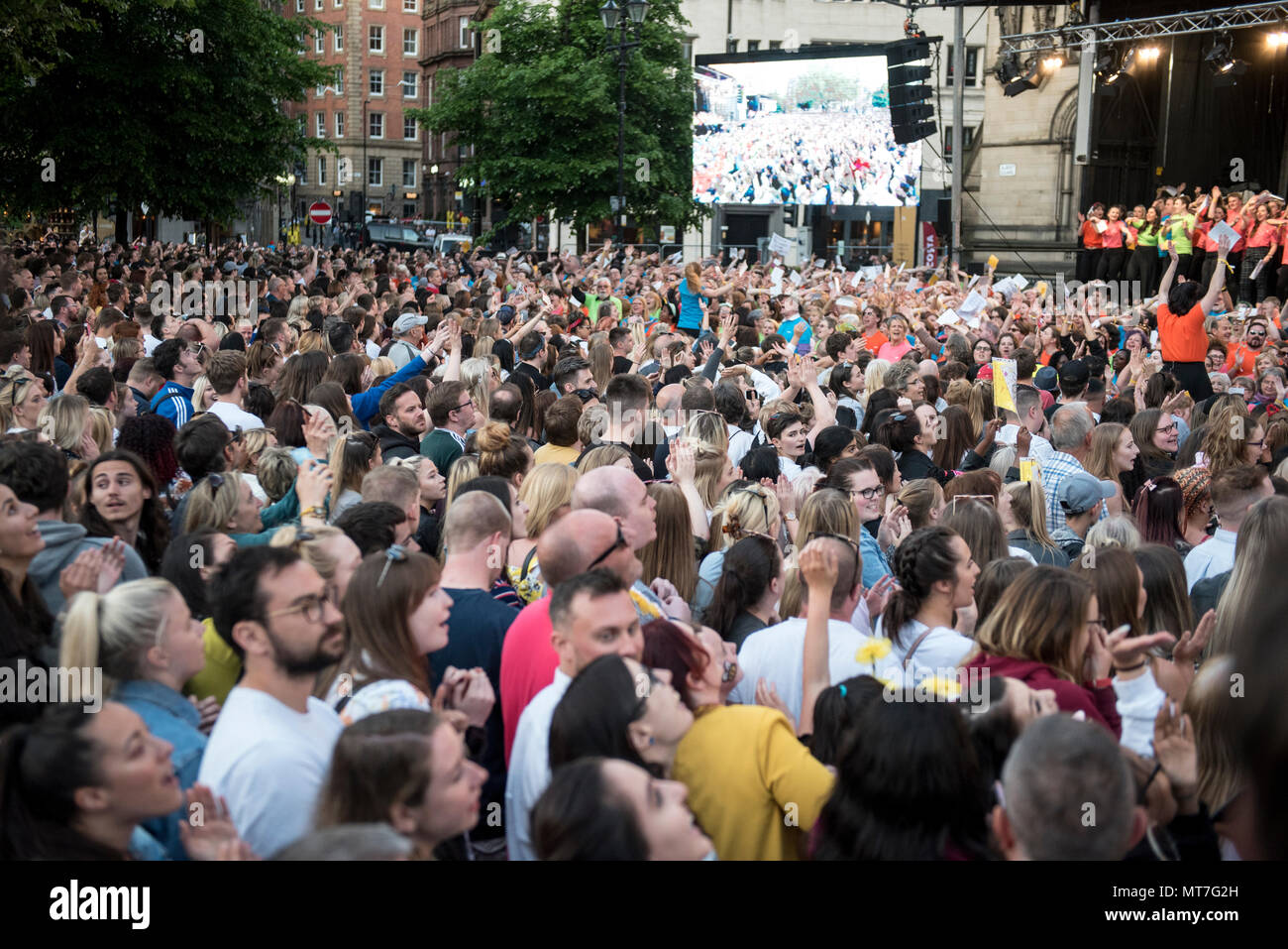 Crowds cheer, dance, and wave their arms during the Manchester Together ...