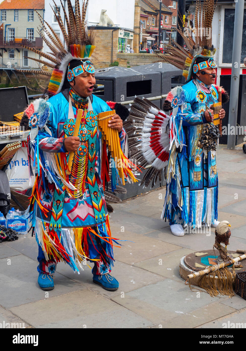 Street musicians in South American costume singing and playing pan ...