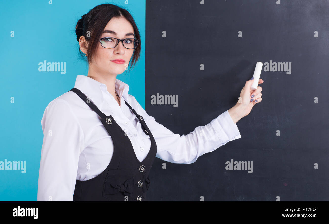 People and education. Teacher writing on math equation on blackboard ...