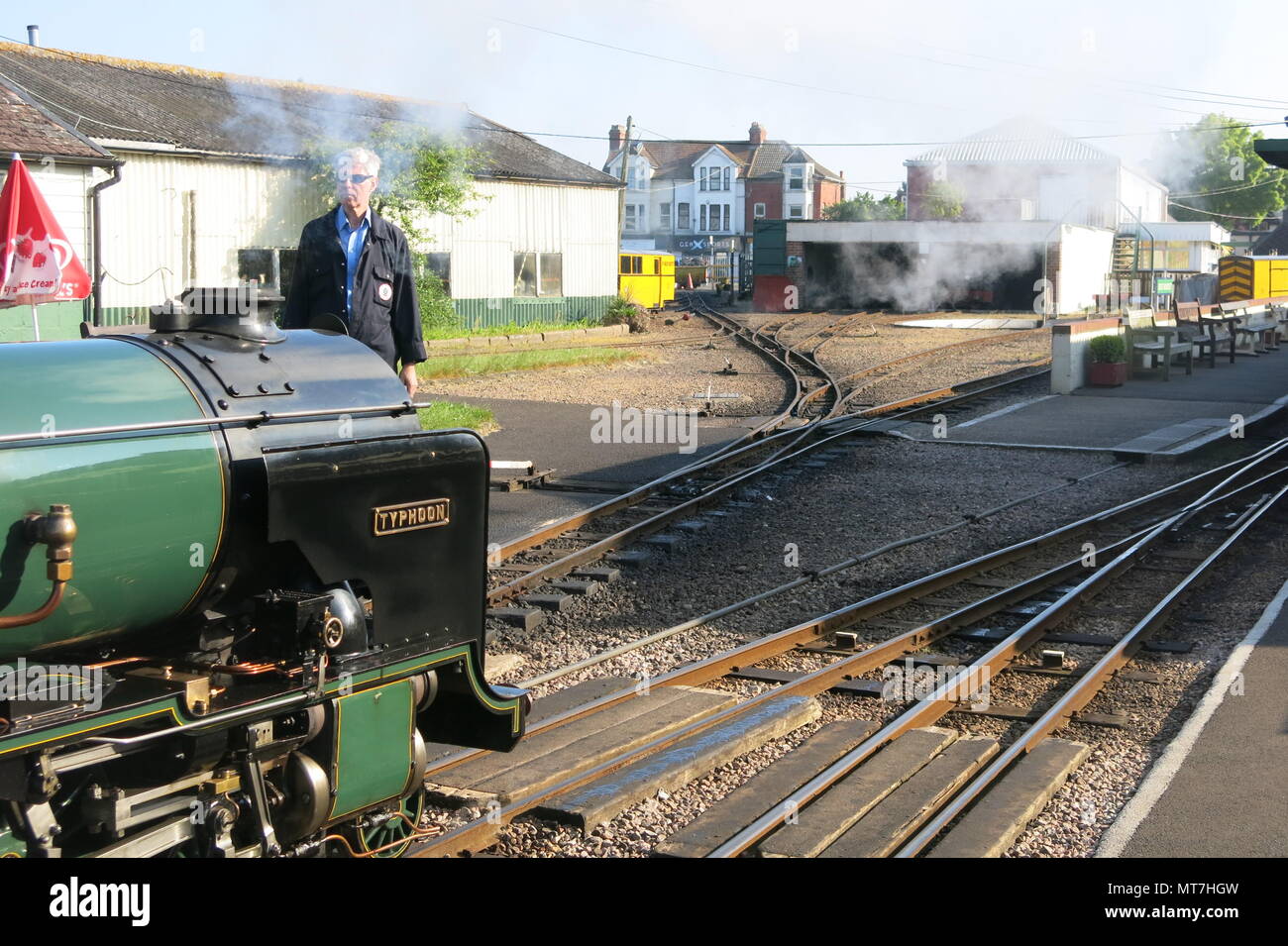 Volunteer at the Romney, Hythe & Dymchurch Railway stands next to the ...