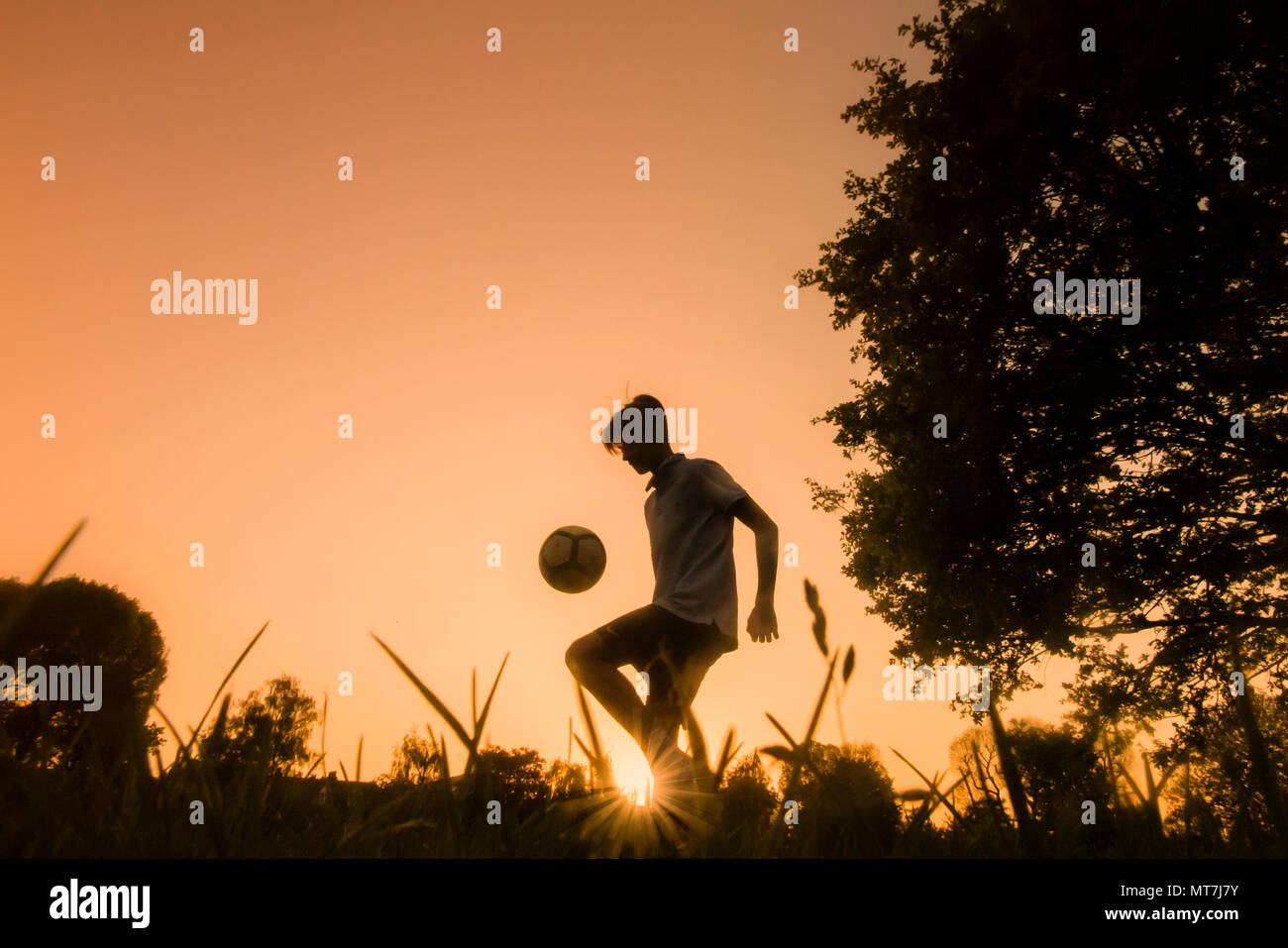 A boy playing football alone hi-res stock photography and images - Alamy