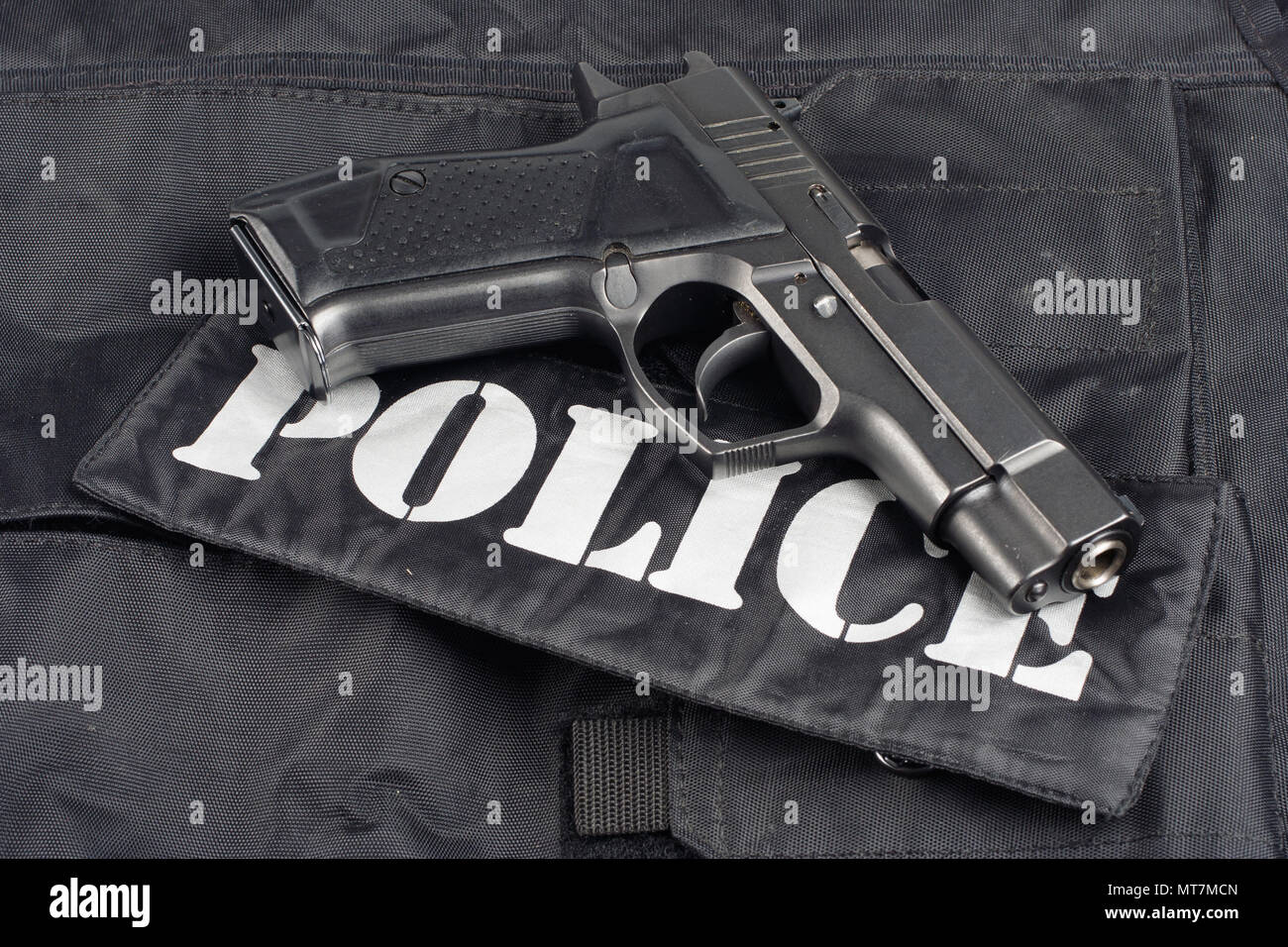 Police concept - handgun on black uniform background Stock Photo - Alamy