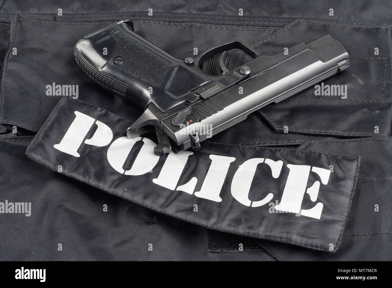 Police concept - handgun on black uniform background Stock Photo - Alamy