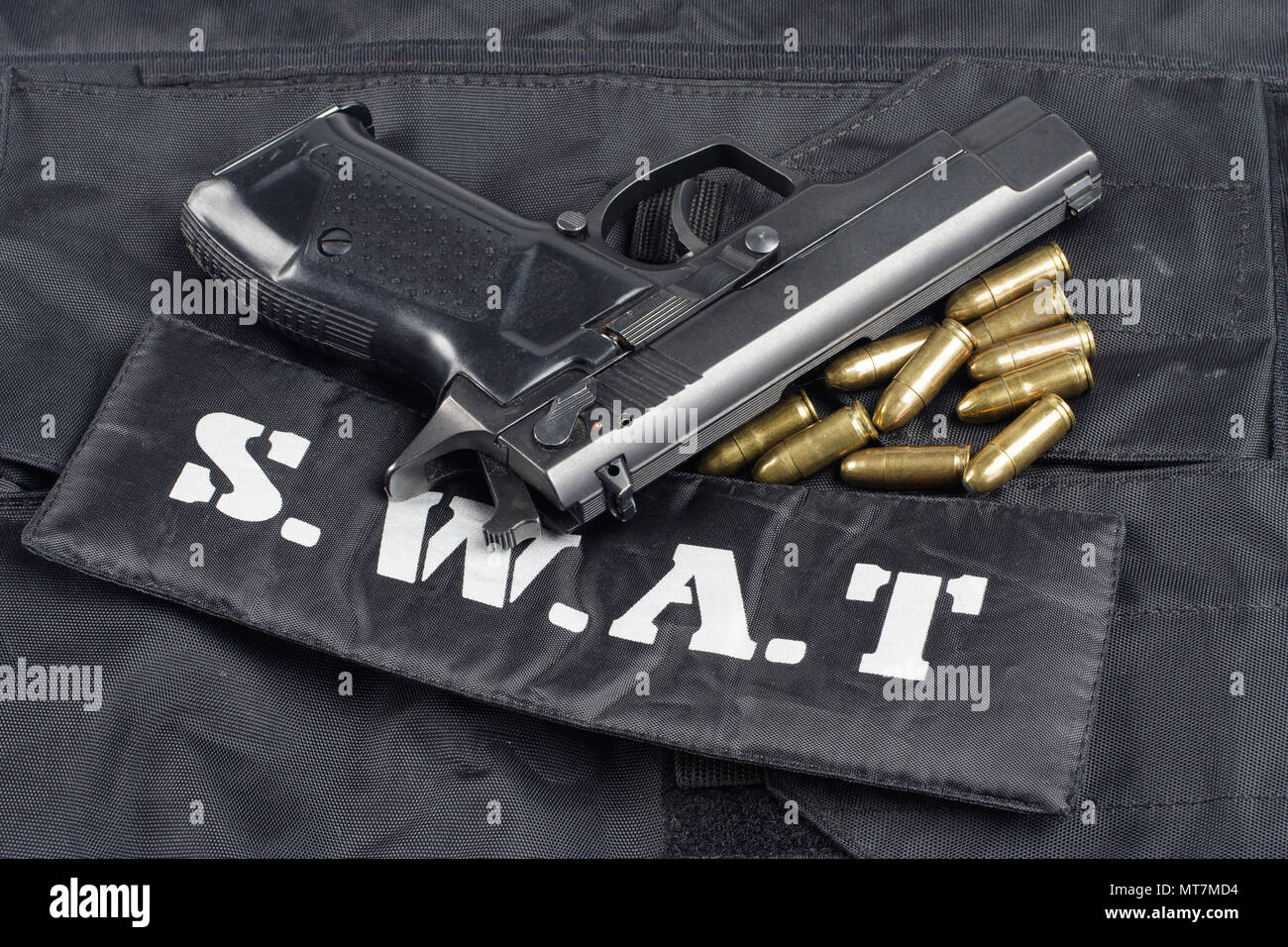 SWAT teams concept -handgun on black uniform background Stock Photo - Alamy