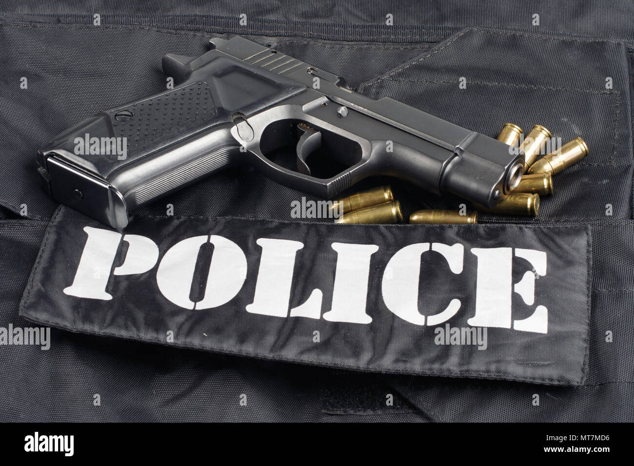 Police concept - handgun on black uniform background Stock Photo - Alamy