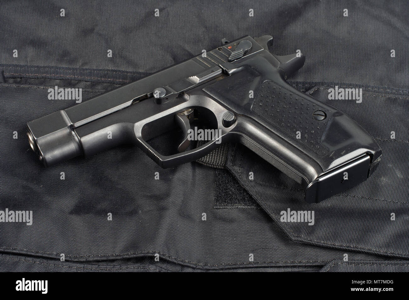Police concept - handgun on black uniform background Stock Photo - Alamy