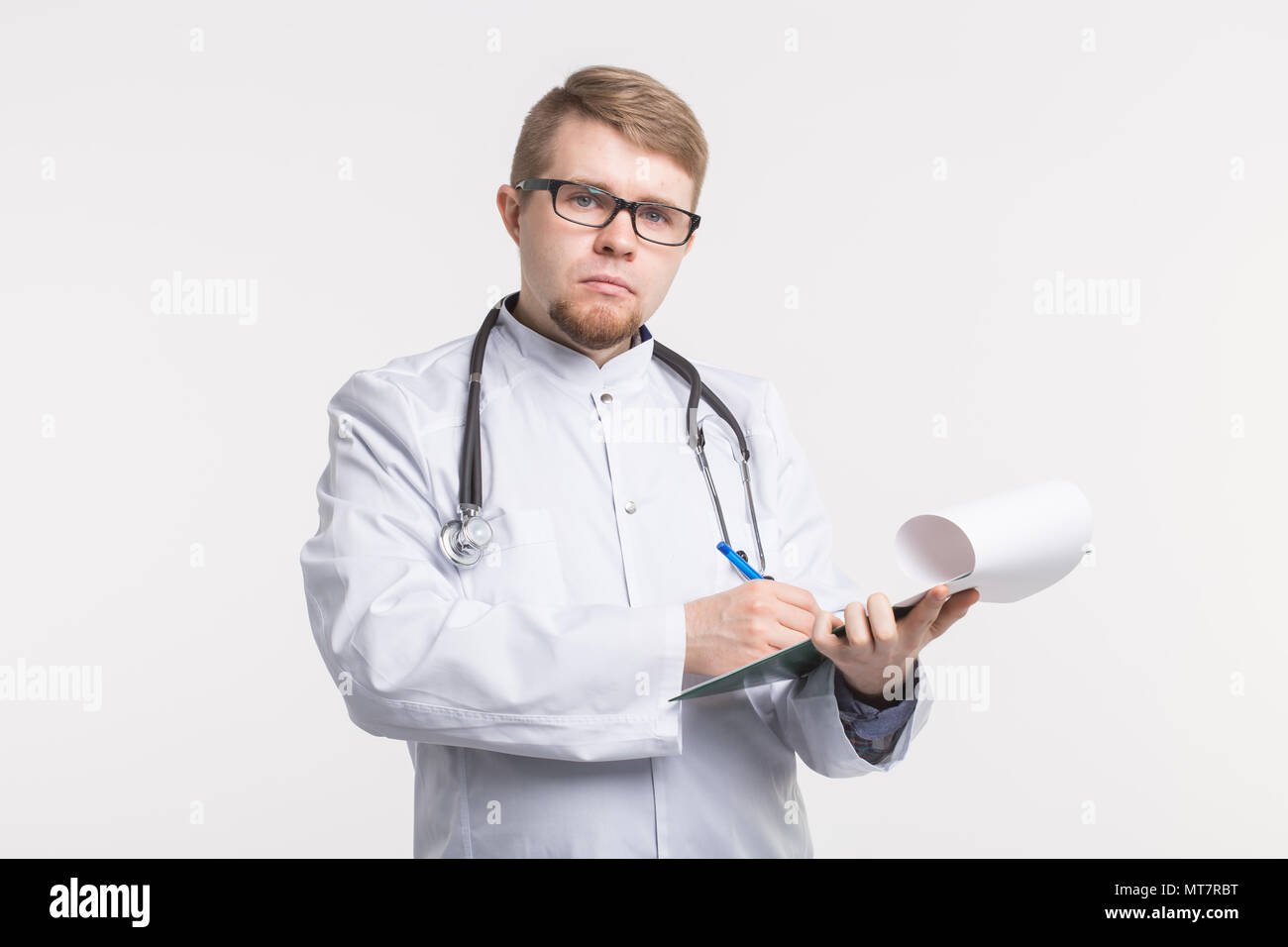 Medical doctor writing prescription over white background Stock Photo ...