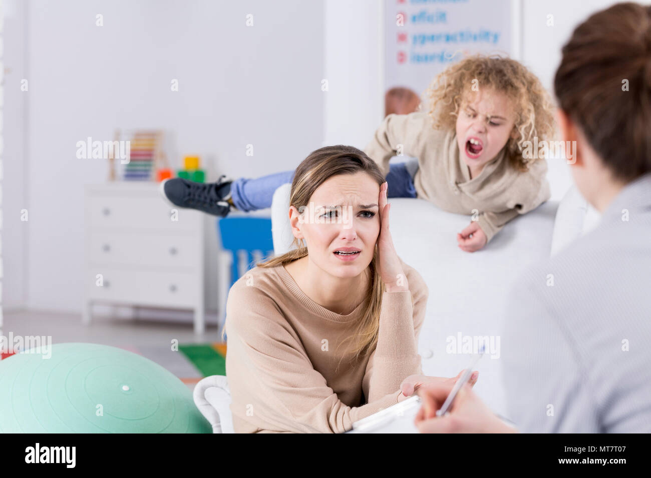 Overactive child and stressed mother having psychological assistance ...