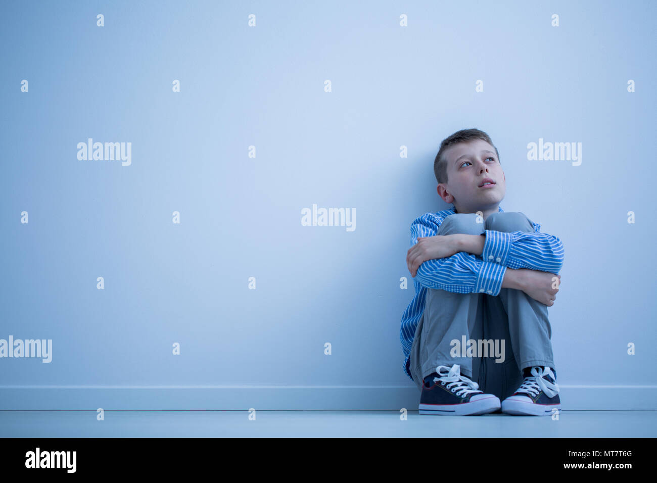 Lonely autistic child sitting on a floor in a room Stock Photo - Alamy