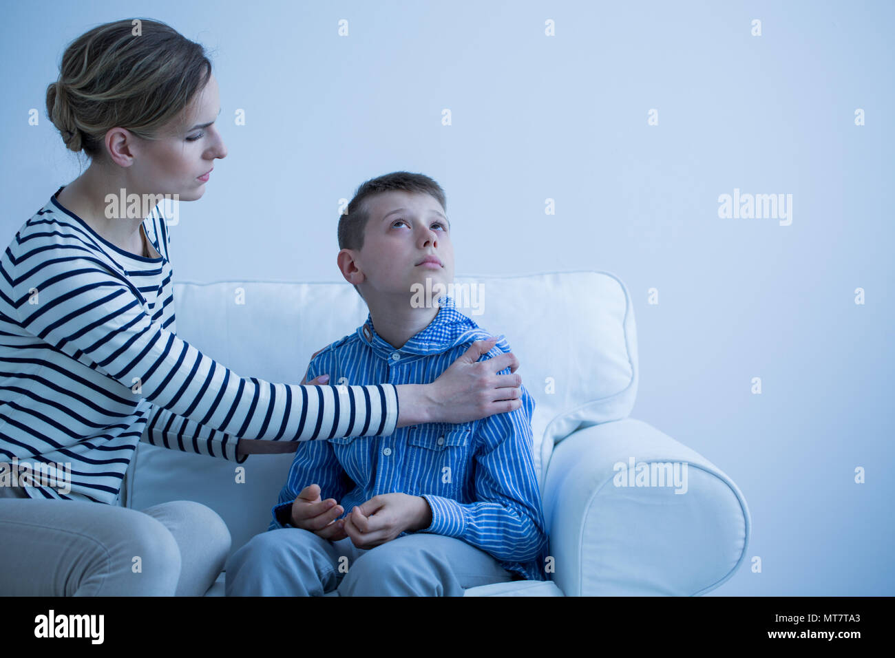 Mother and her autistic son sitting on the sofa Stock Photo - Alamy