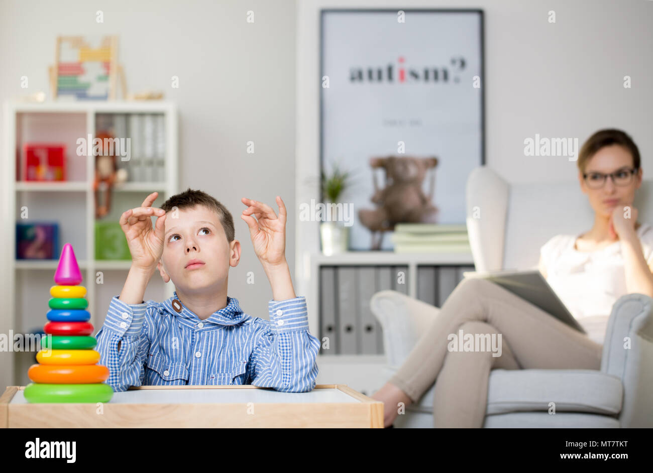 Professional psychologist observing an autistic boy in her office Stock ...