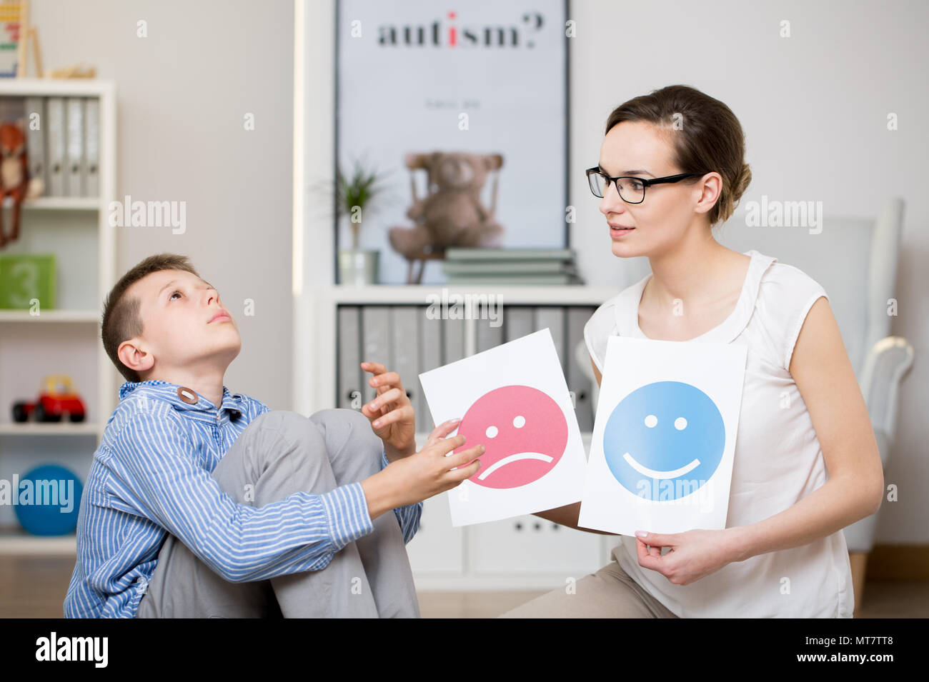 Professional psychologist working with autistic boy in her office Stock ...
