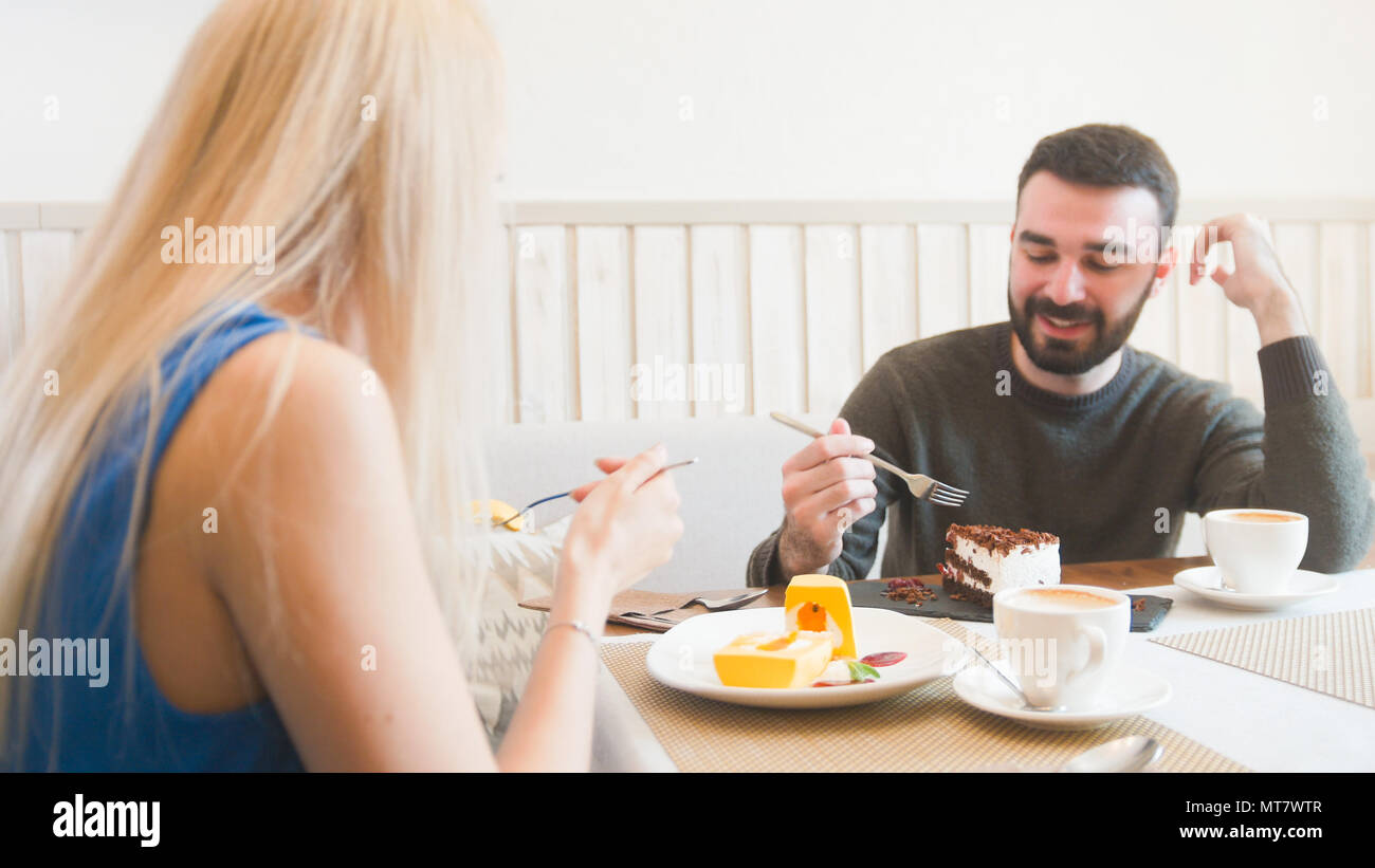 Man and woman eating desserts in a cafe, romantic rendezvous Stock ...