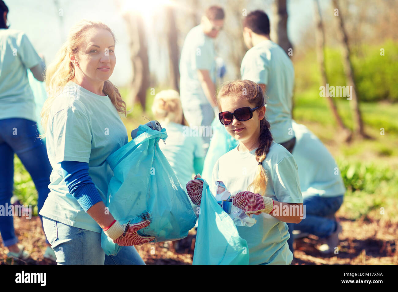 volunteers with garbage bags cleaning park area Stock Photo - Alamy