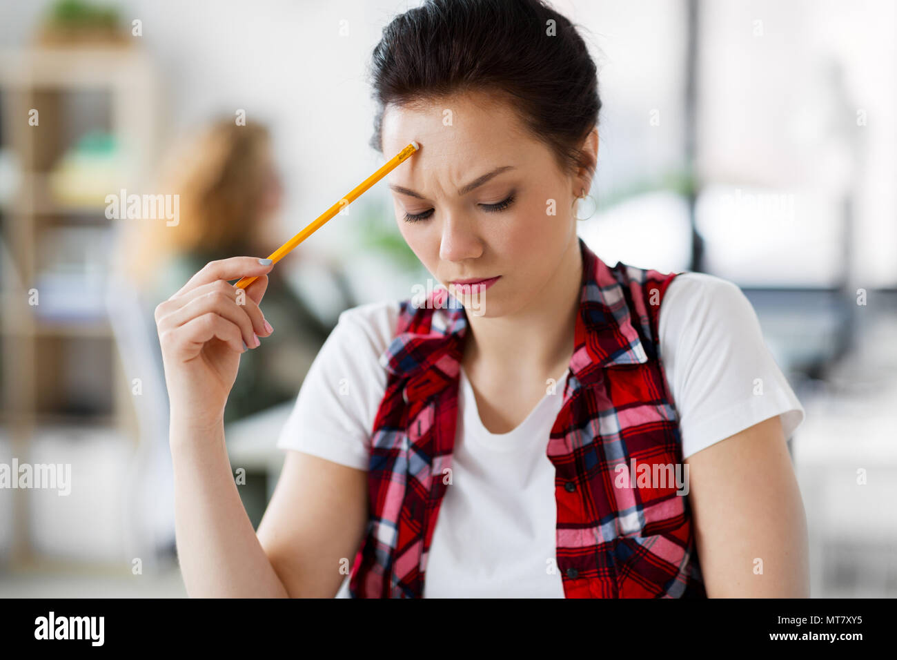 Woman thinking holding pencil hi-res stock photography and images - Alamy