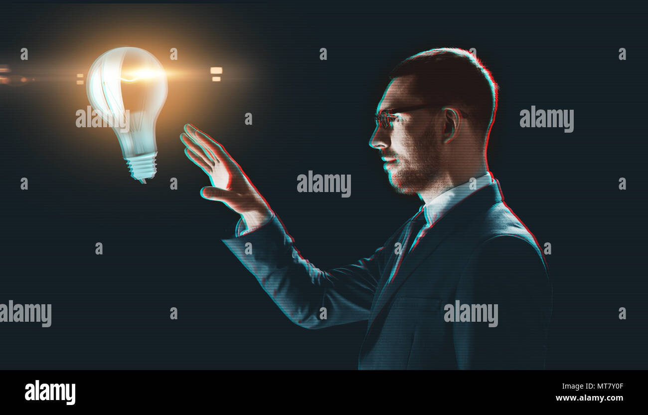 businessman with virtual light bulb projection Stock Photo - Alamy