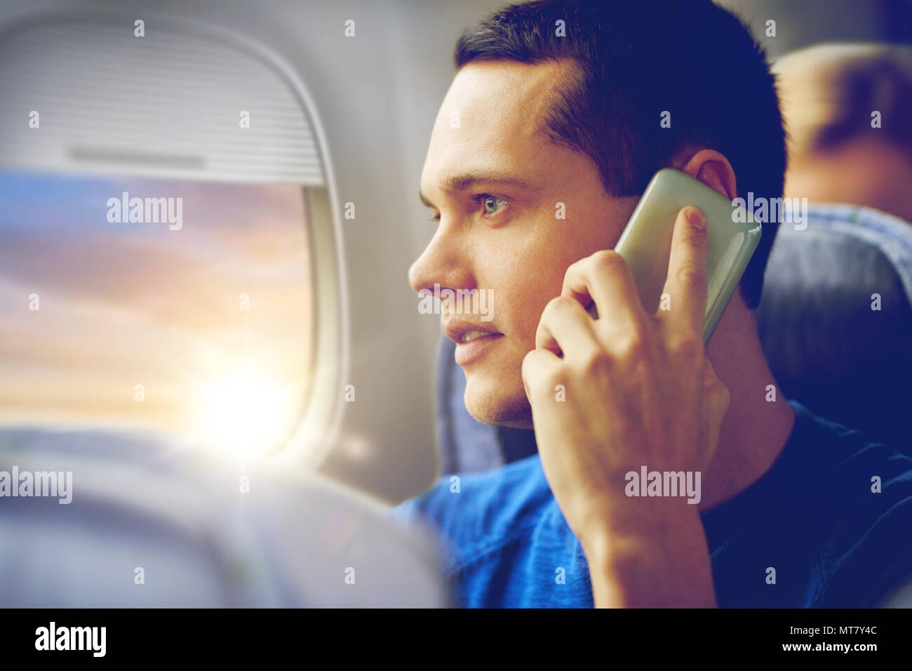 Man talking on phone on plane hi-res stock photography and images - Alamy