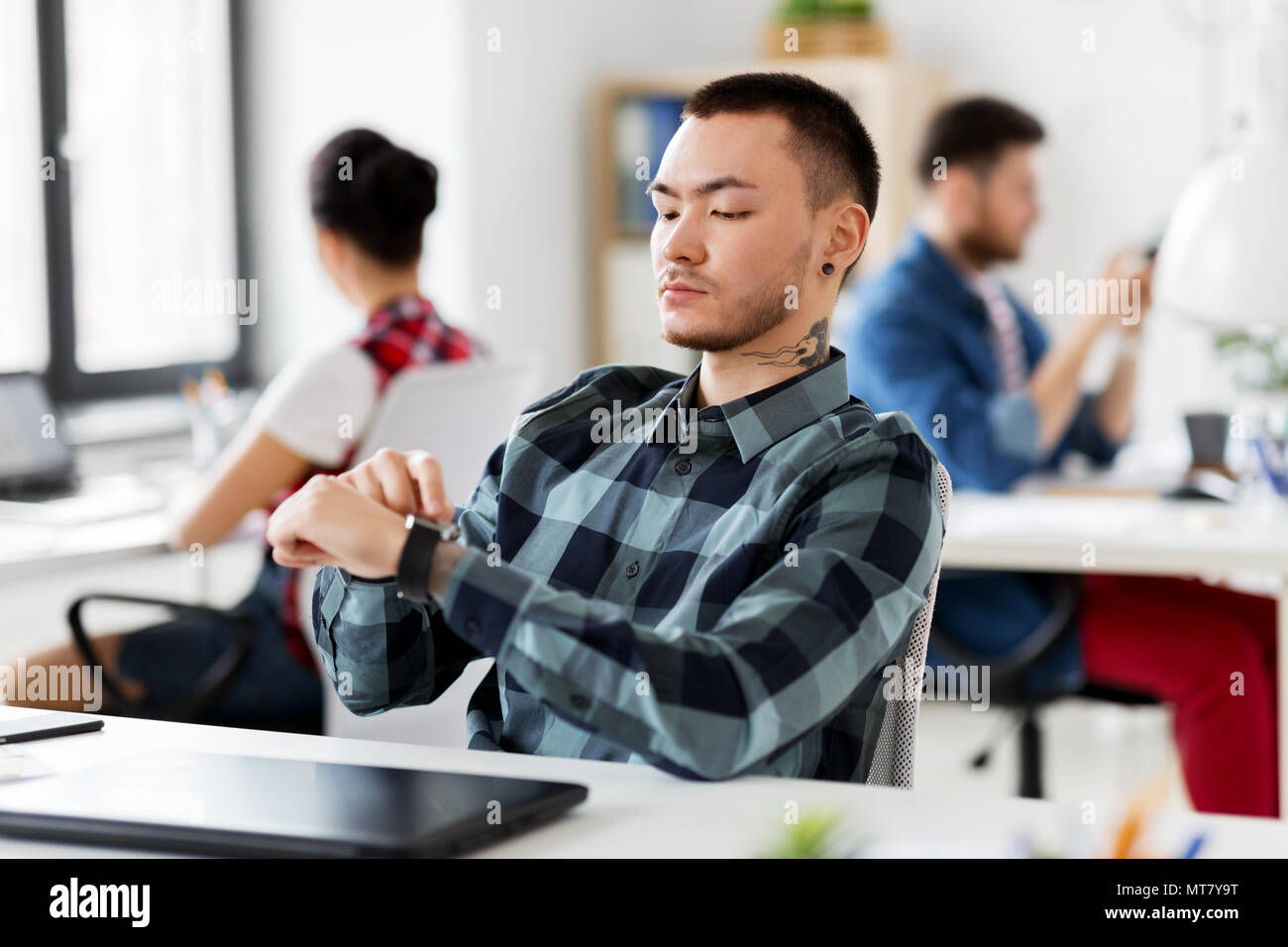 creative man with smart watch working at office Stock Photo - Alamy