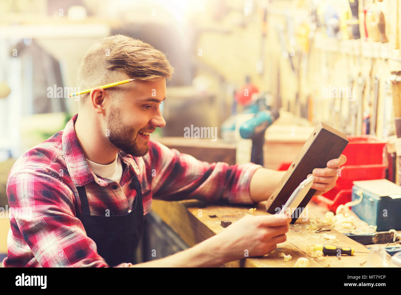 carpenter working with wood plank at workshop Stock Photo - Alamy