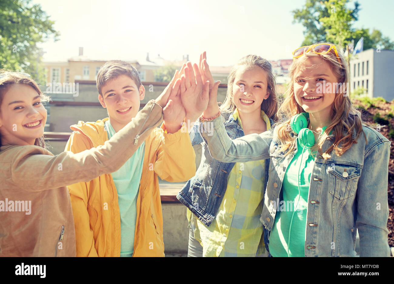 happy students or friends making high five Stock Photo - Alamy