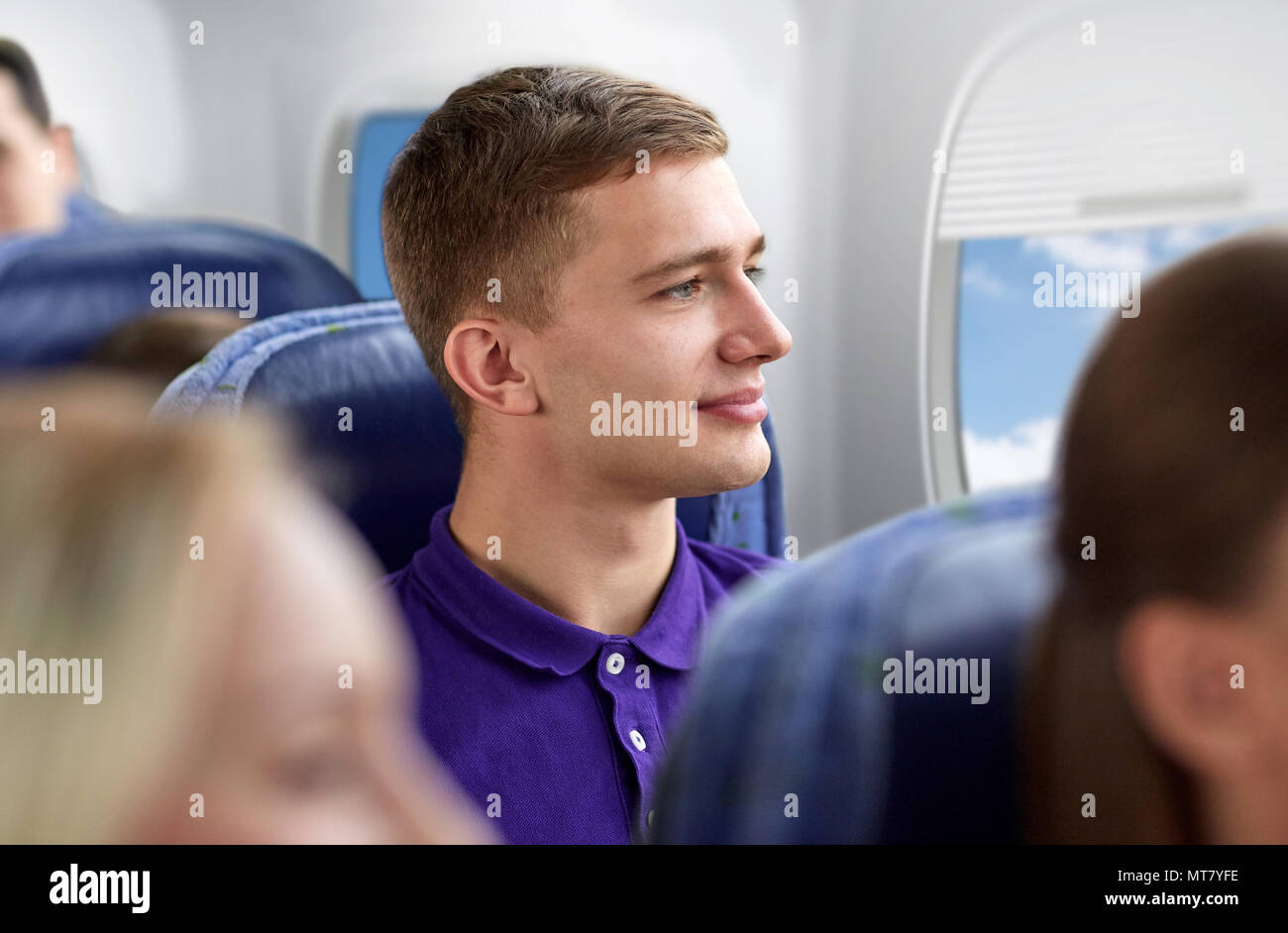 happy young man travelling by plane Stock Photo - Alamy