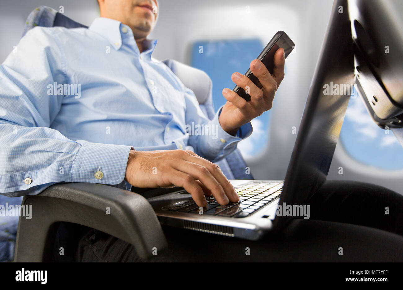 Businessman cell phone plane hi-res stock photography and images - Alamy