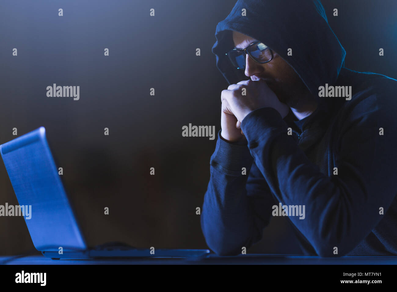 hacker with laptop computer in dark room Stock Photo - Alamy
