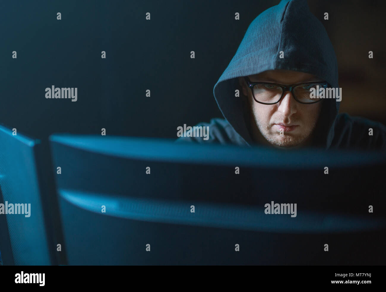 close up of hacker in hood at computer monitor Stock Photo - Alamy