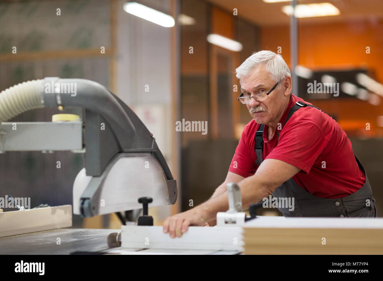 carpenter with panel saw and fibreboard at factory Stock Photo - Alamy