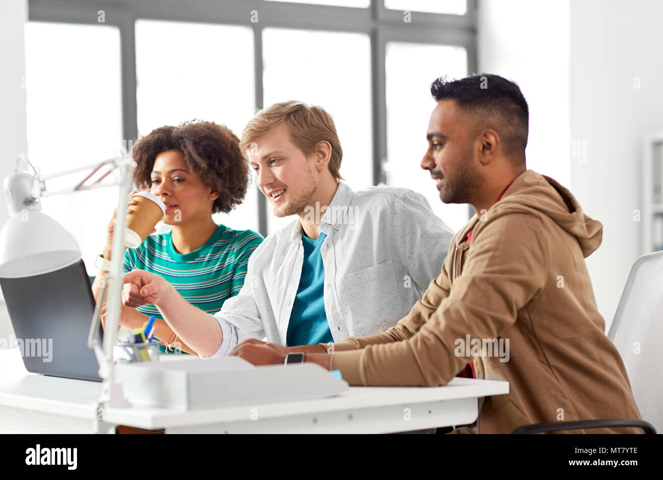 happy creative workers with laptops at office Stock Photo - Alamy