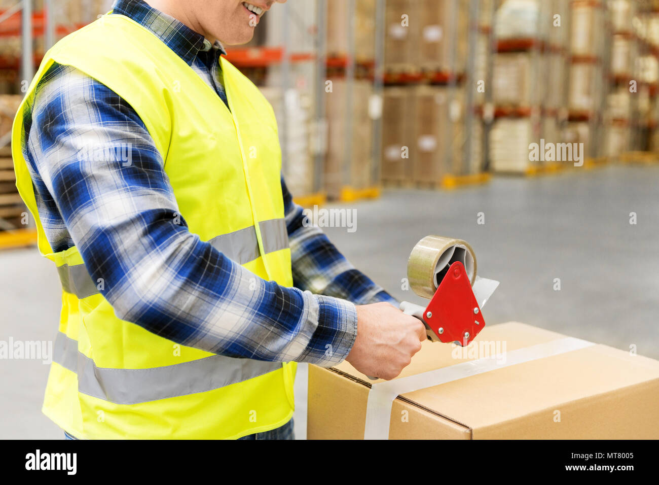 warehouse worker packing parcel with scotch tape Stock Photo - Alamy