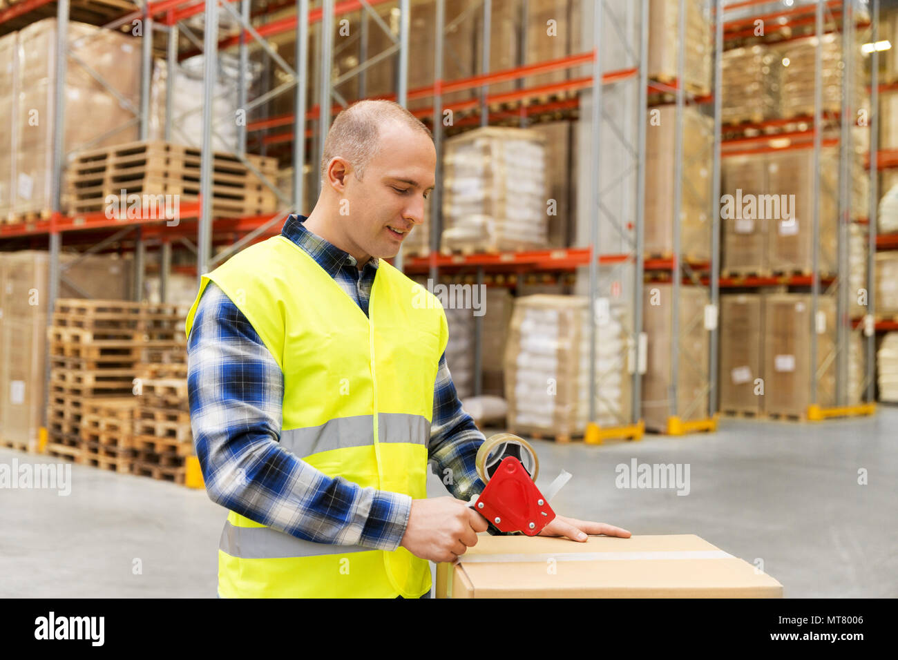warehouse worker packing parcel with scotch tape Stock Photo - Alamy