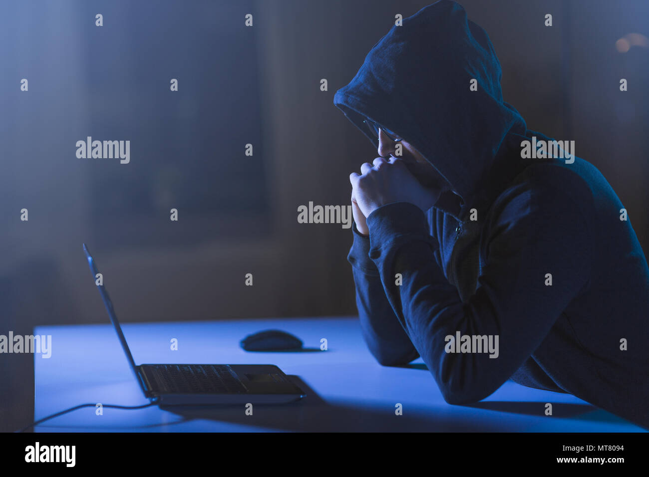 hacker with laptop computer in dark room Stock Photo - Alamy