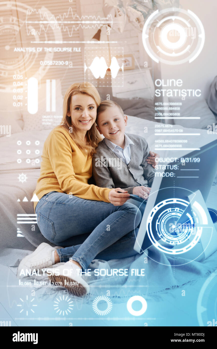 Cheerful mother hugging her son and looking happy Stock Photo - Alamy
