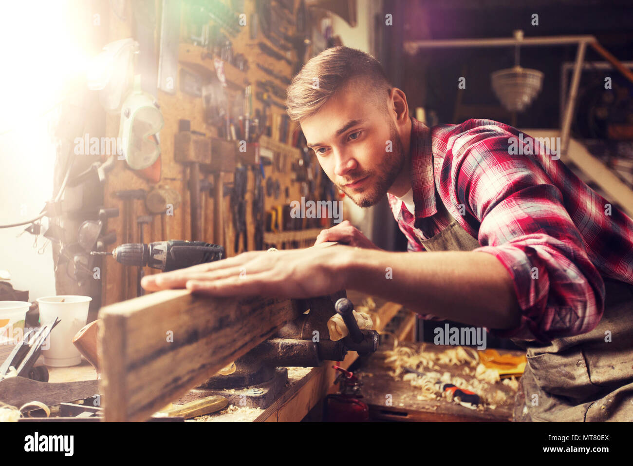 carpenter working with wood plank at workshop Stock Photo - Alamy