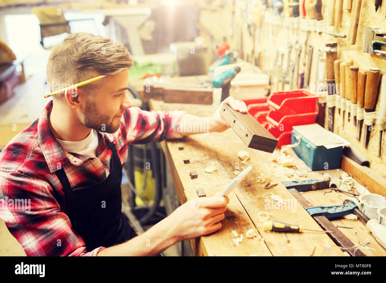 carpenter working with wood plank at workshop Stock Photo - Alamy