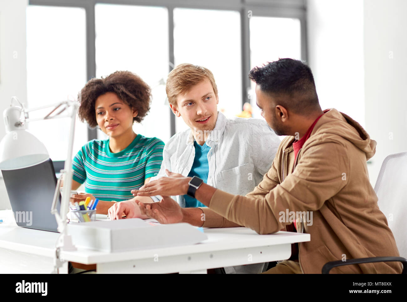 happy creative workers with laptops at office Stock Photo - Alamy