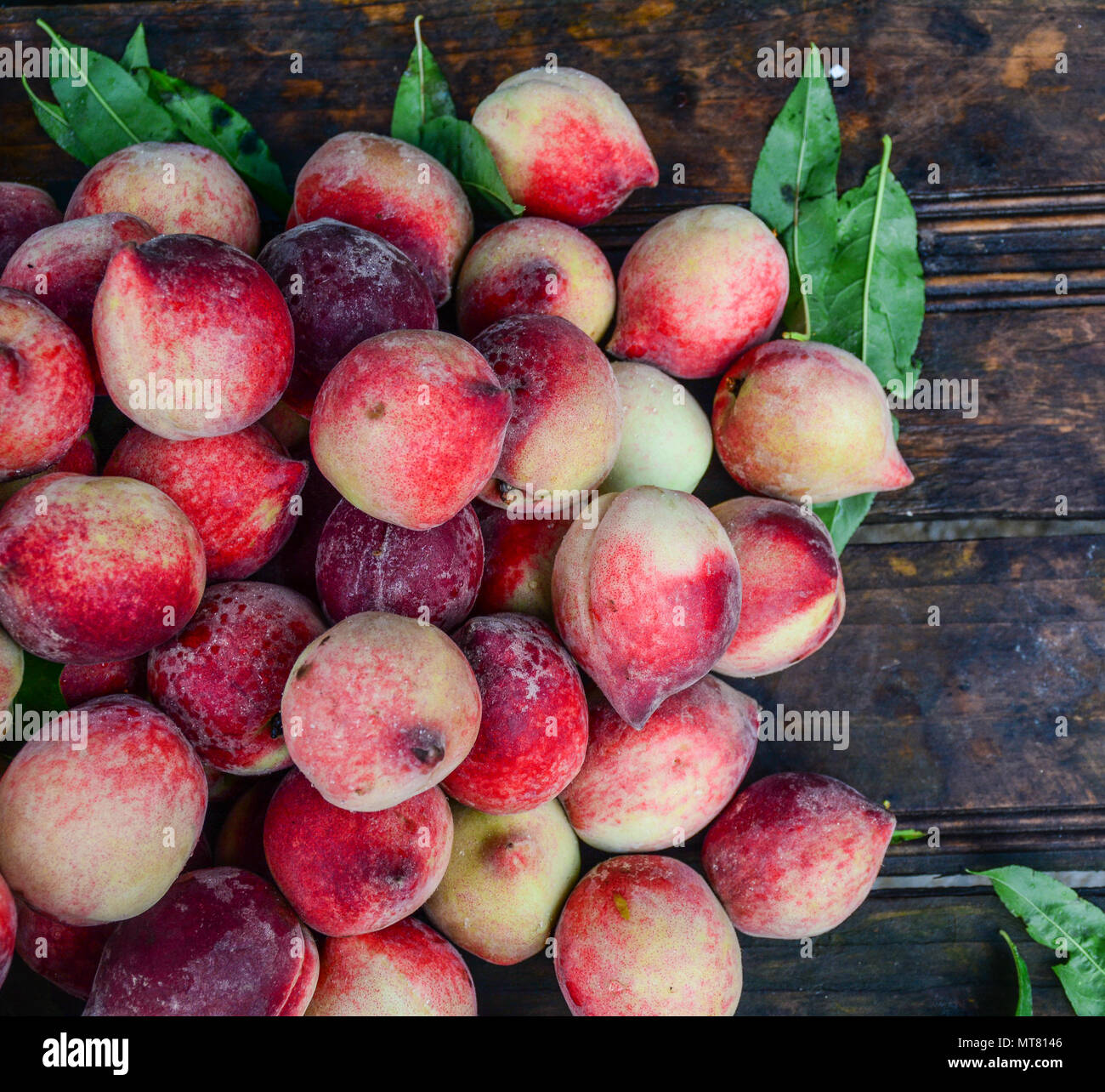 Red peach fruits on wooden table in Sapa, North of Vietnam Stock Photo ...