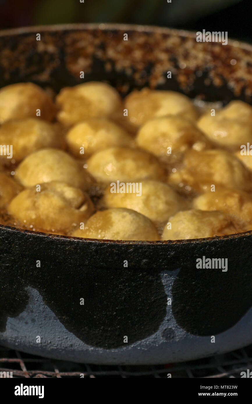 Caribbean flour dumplings frying in hot oil Stock Photo - Alamy