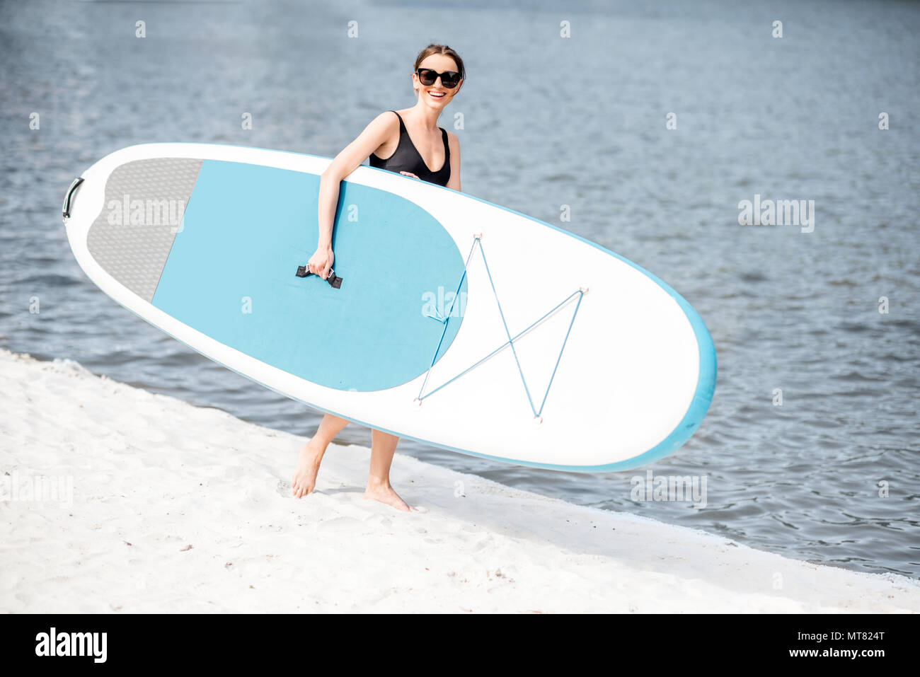 Smiling Woman Holding Paddle Stock Photos & Smiling Woman Holding ...