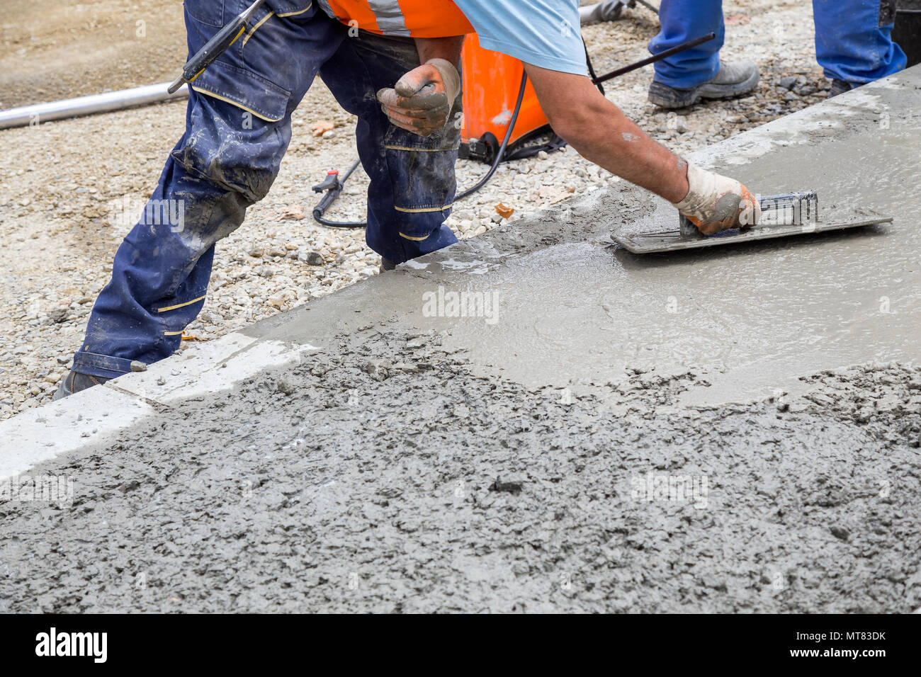 Builder hand leveling concrete with trowel, spreading poured Stock ...
